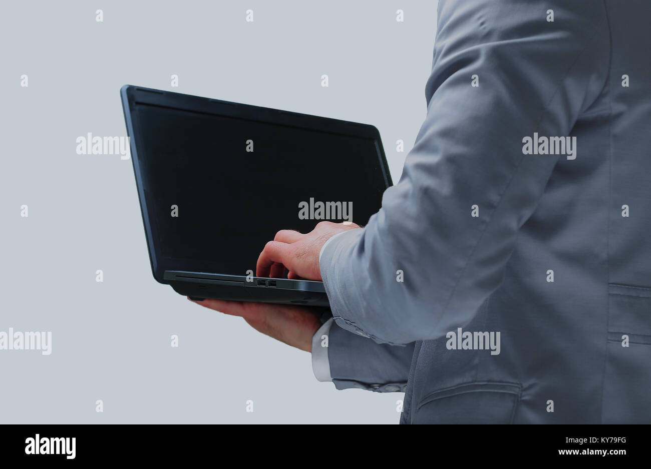 Handsome businessman holding a laptop Stock Photo - Alamy