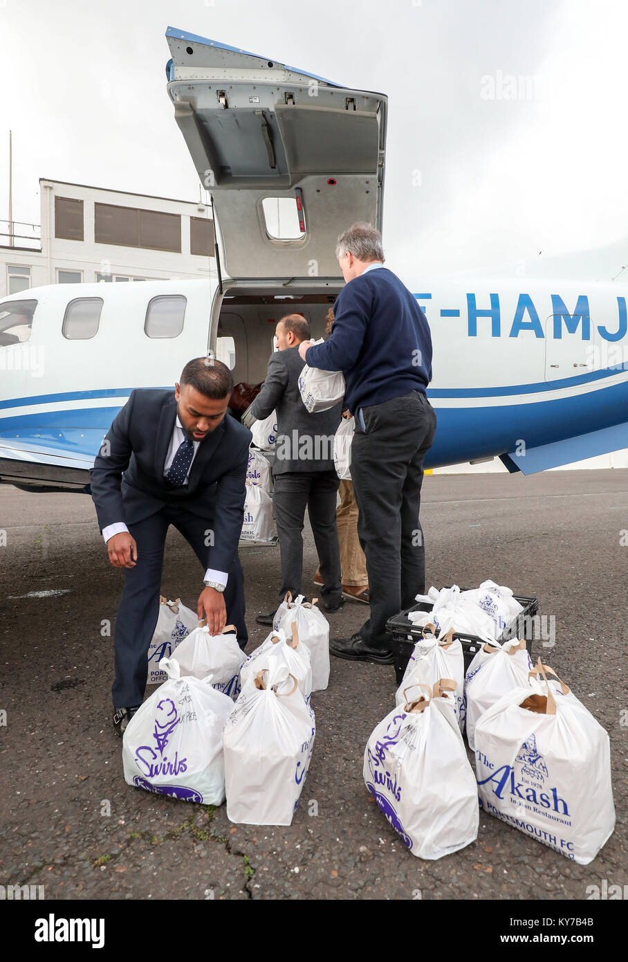 Jaf Ahmed (left) from the Akash restaurant in Southsea, Hampshire, load ...