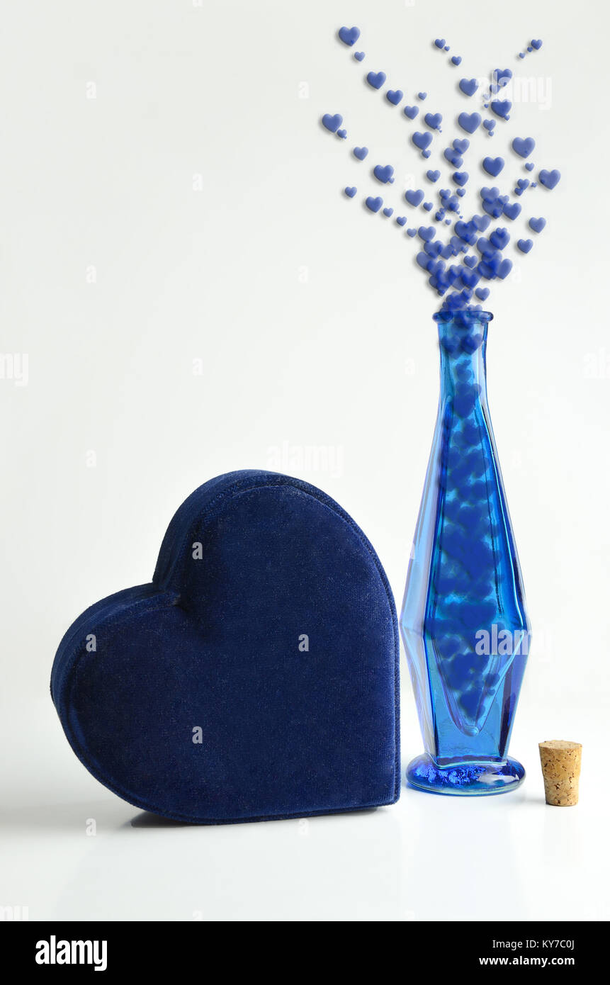 Blue velvet shaped heart box and an overflowing bottle of hearts Stock ...