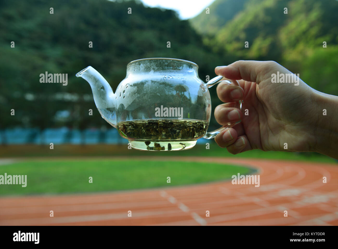 Pour water with glass teapot Stock Photo - Alamy
