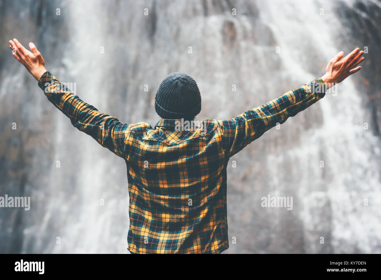 Man enjoying waterfall raised hands Travel Lifestyle adventure concept ...