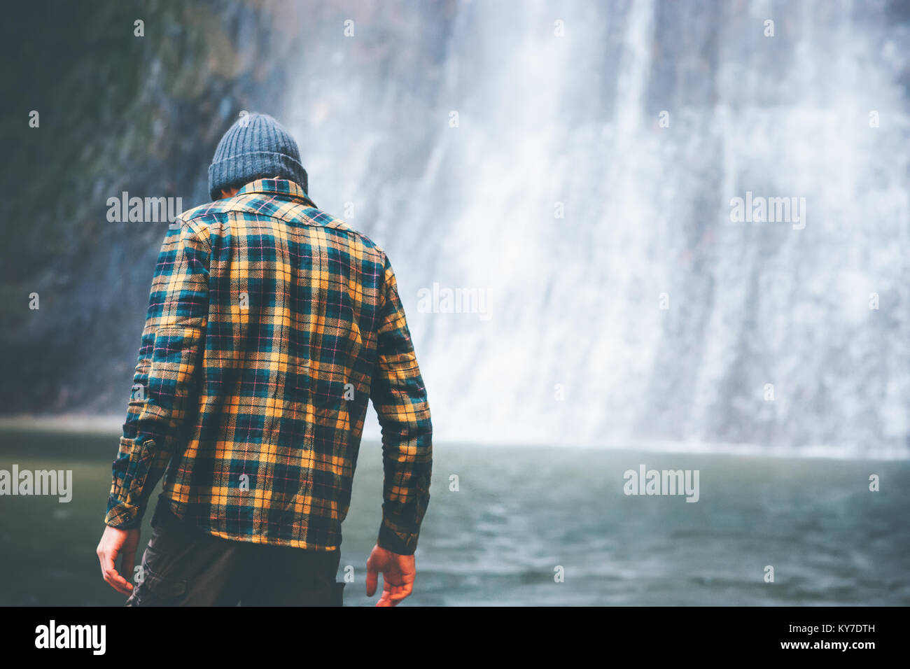 Man walking at waterfall alone Travel Lifestyle adventure concept ...