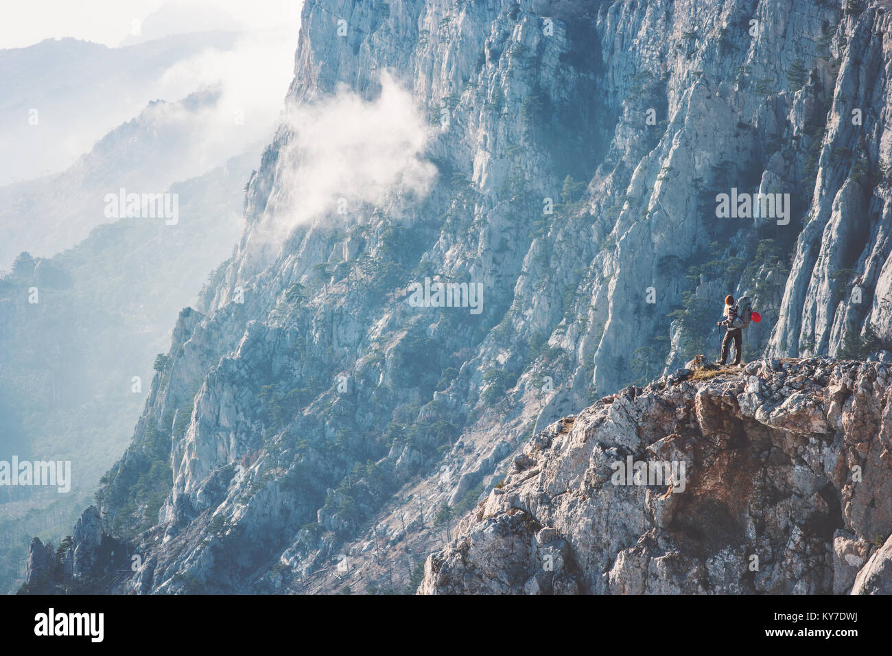 Traveler on cliff hiking with backpack Travel Lifestyle concept ...
