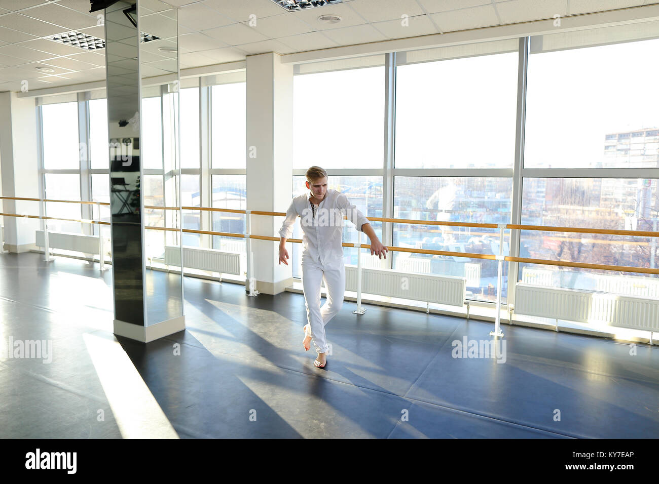Guy spotting in white suit and raving at studio Stock Photo - Alamy