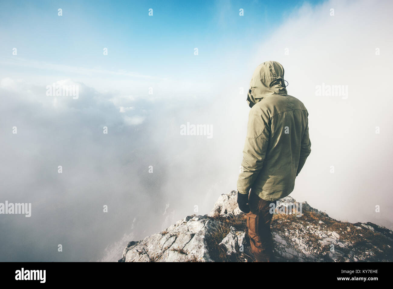 Traveler man alone on mountain summit over clouds Travel Lifestyle ...