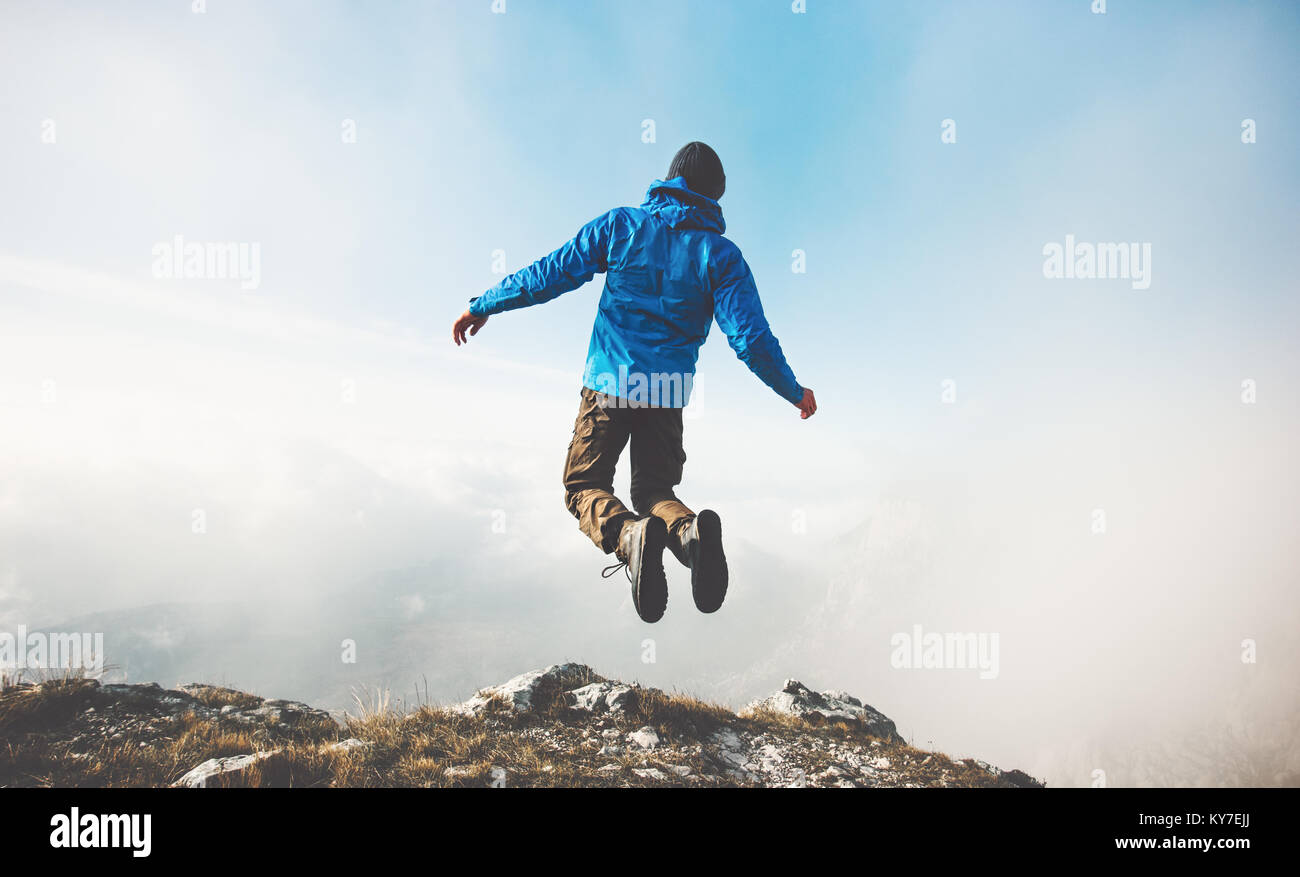 Happy Man jumping on mountains cliff to clouds sky Lifestyle Travel ...