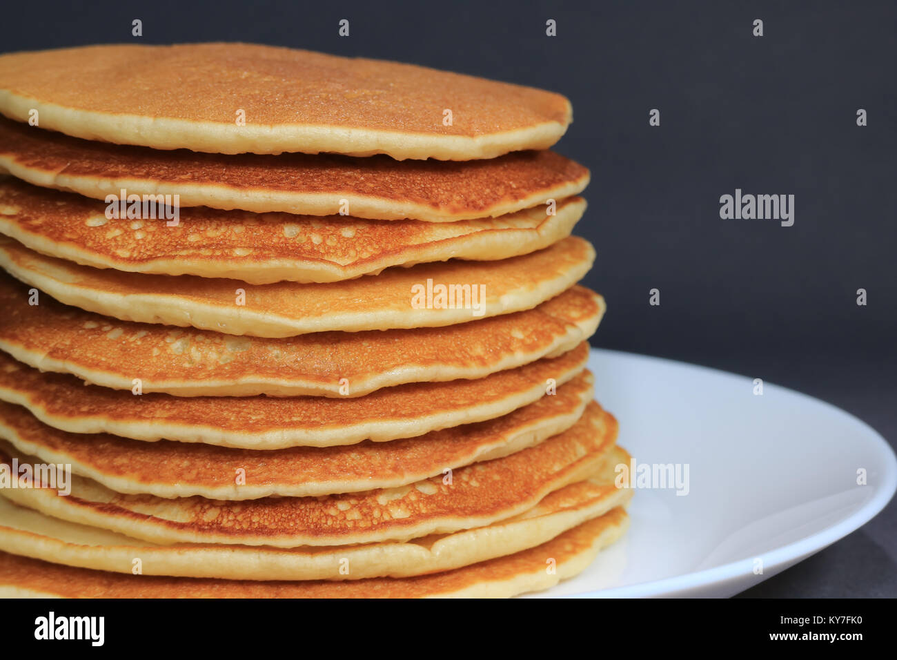 Front view of Stack of homemade plain pancakes served on white plate on ...