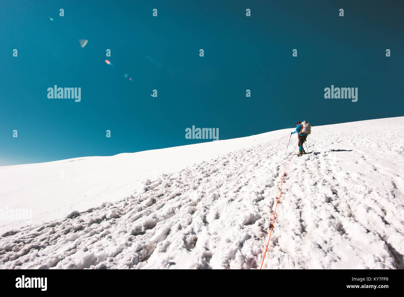 Man climbing to mountain summit on glacier Travel Lifestyle concept ...