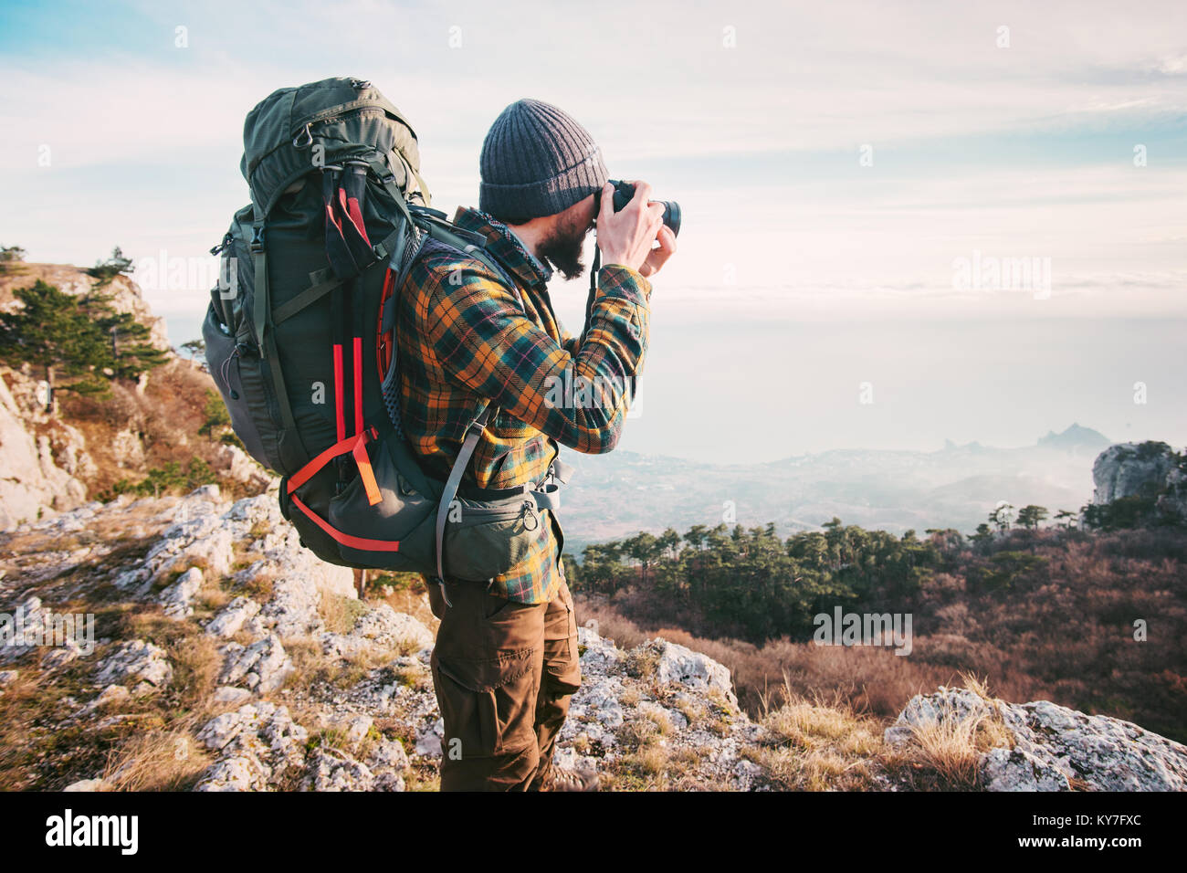 Man traveler photographer with backpack and camera taking photo of ...