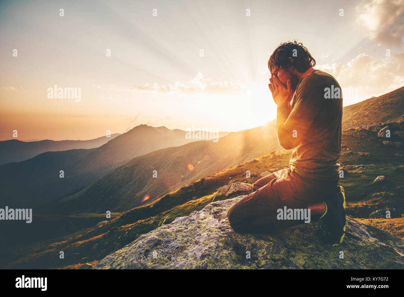 Man praying at sunset mountains Travel Lifestyle spiritual relaxation ...