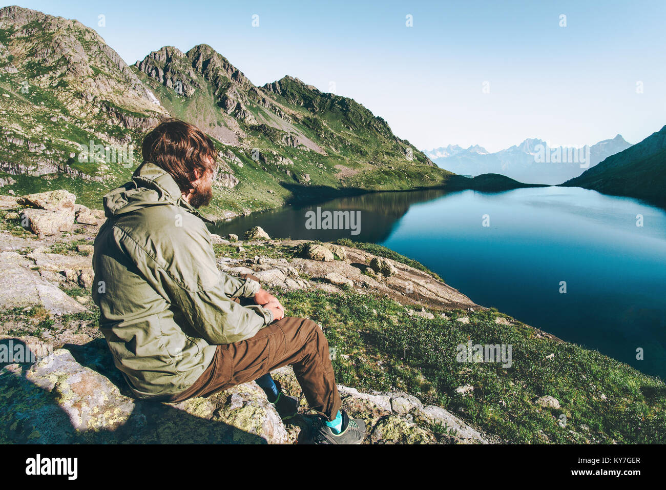 Wanderer Man enjoying lake and mountains view raised hands Travel ...