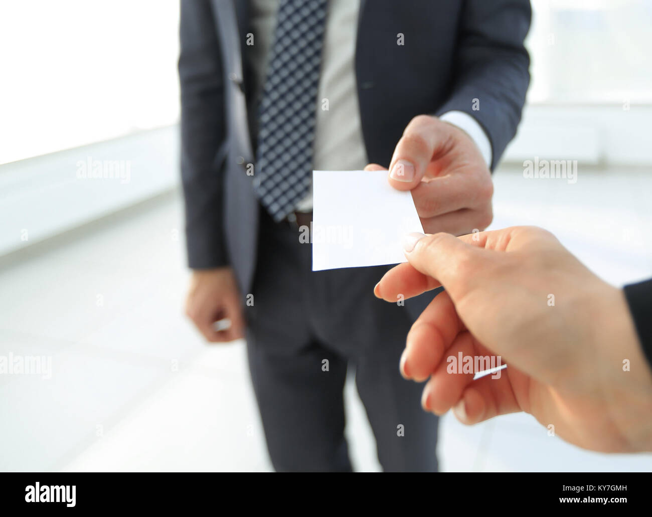 Exchange business card for first time meet Stock Photo - Alamy