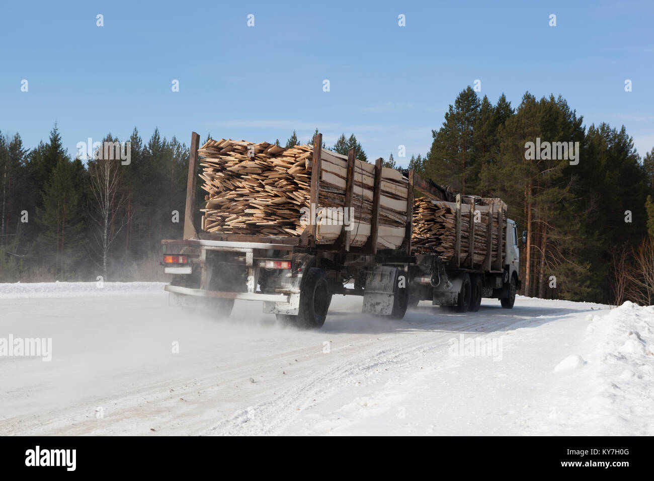 Timber-driven board on winter road Stock Photo - Alamy