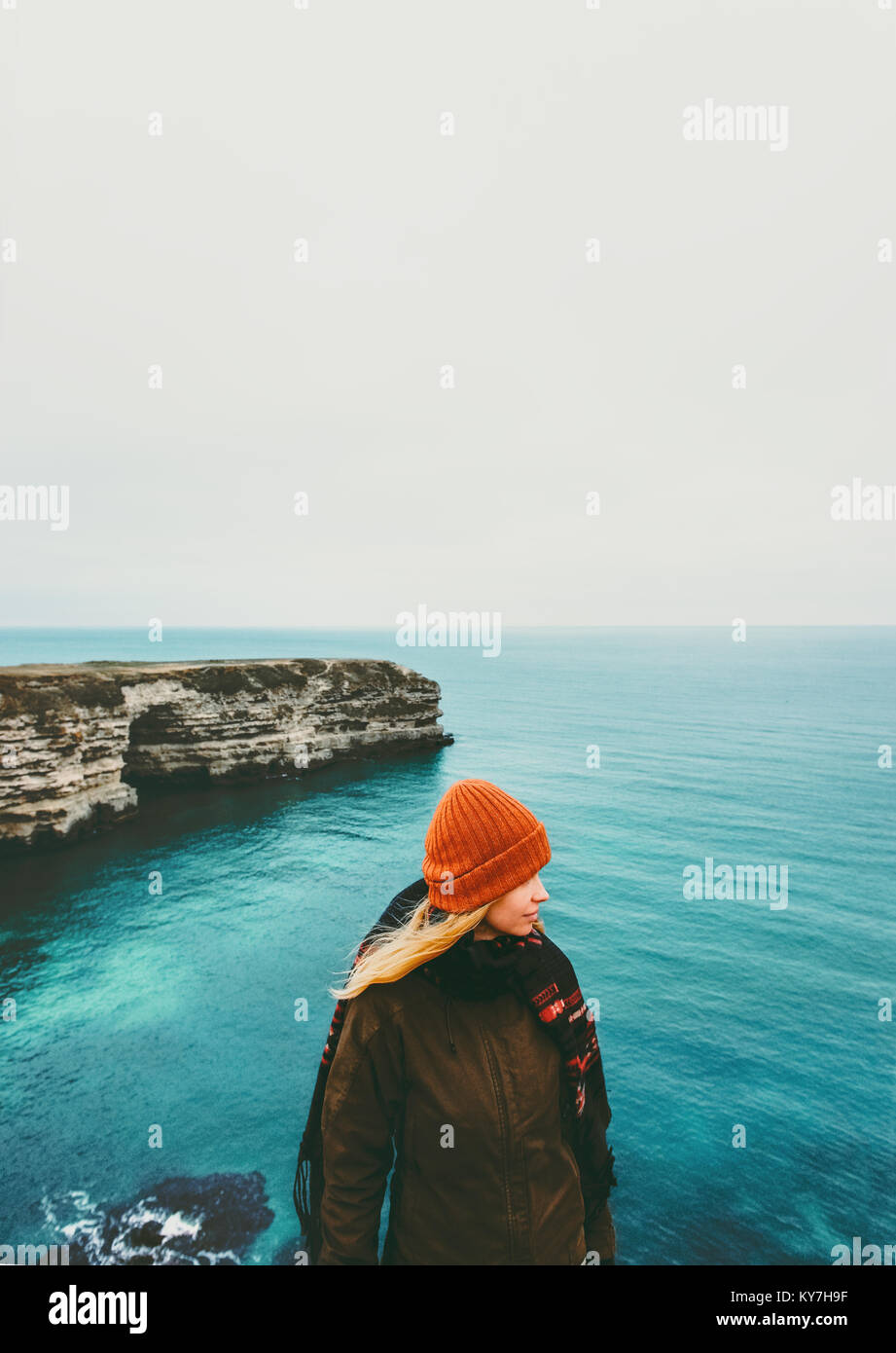 Woman walking at cold sea view alone Travel Lifestyle concept adventure ...