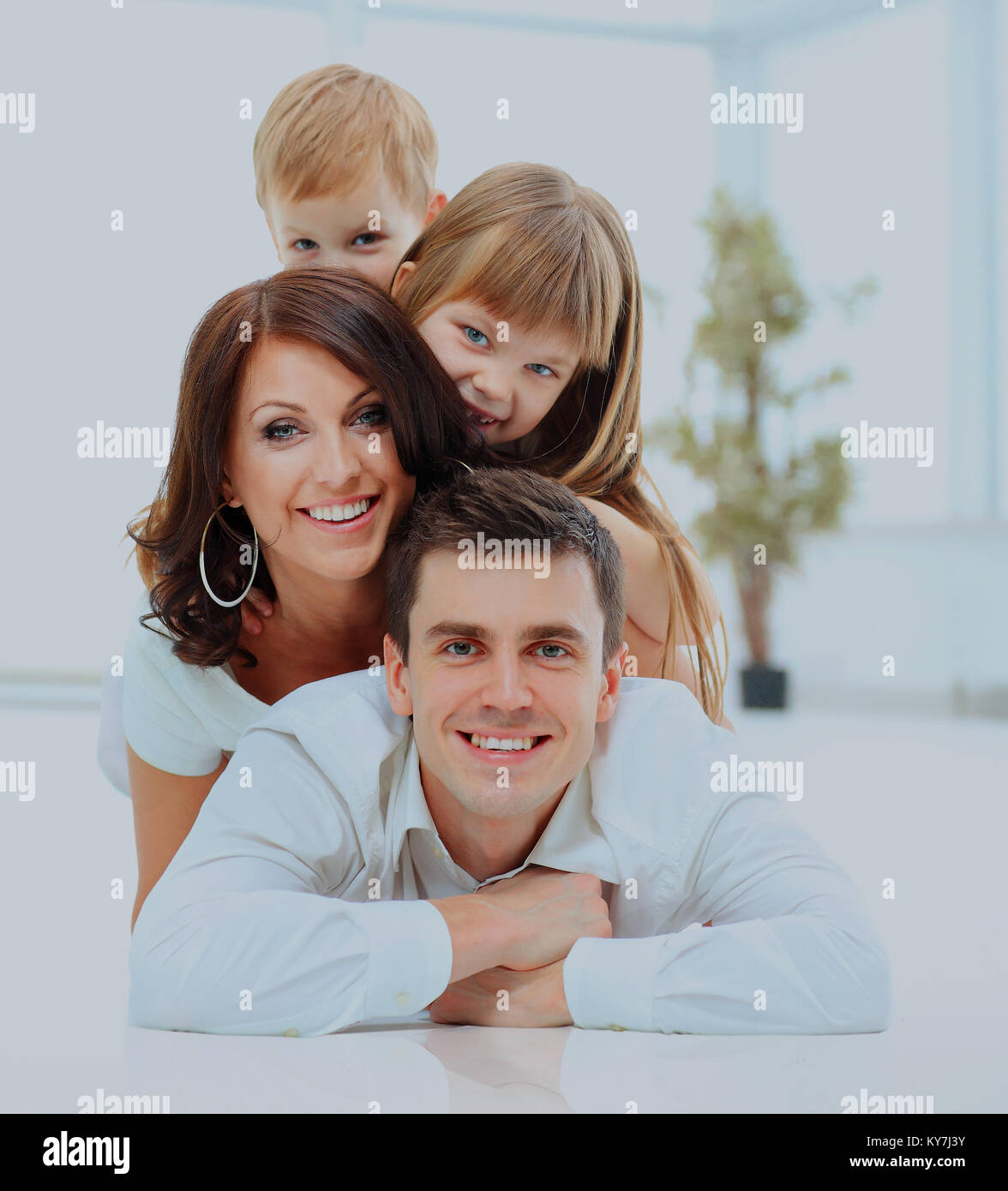 The pyramide of the smiling happy family Stock Photo - Alamy