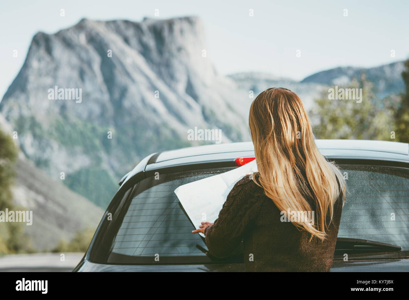 Road trip Woman car driver with map planning journey route in Norway ...