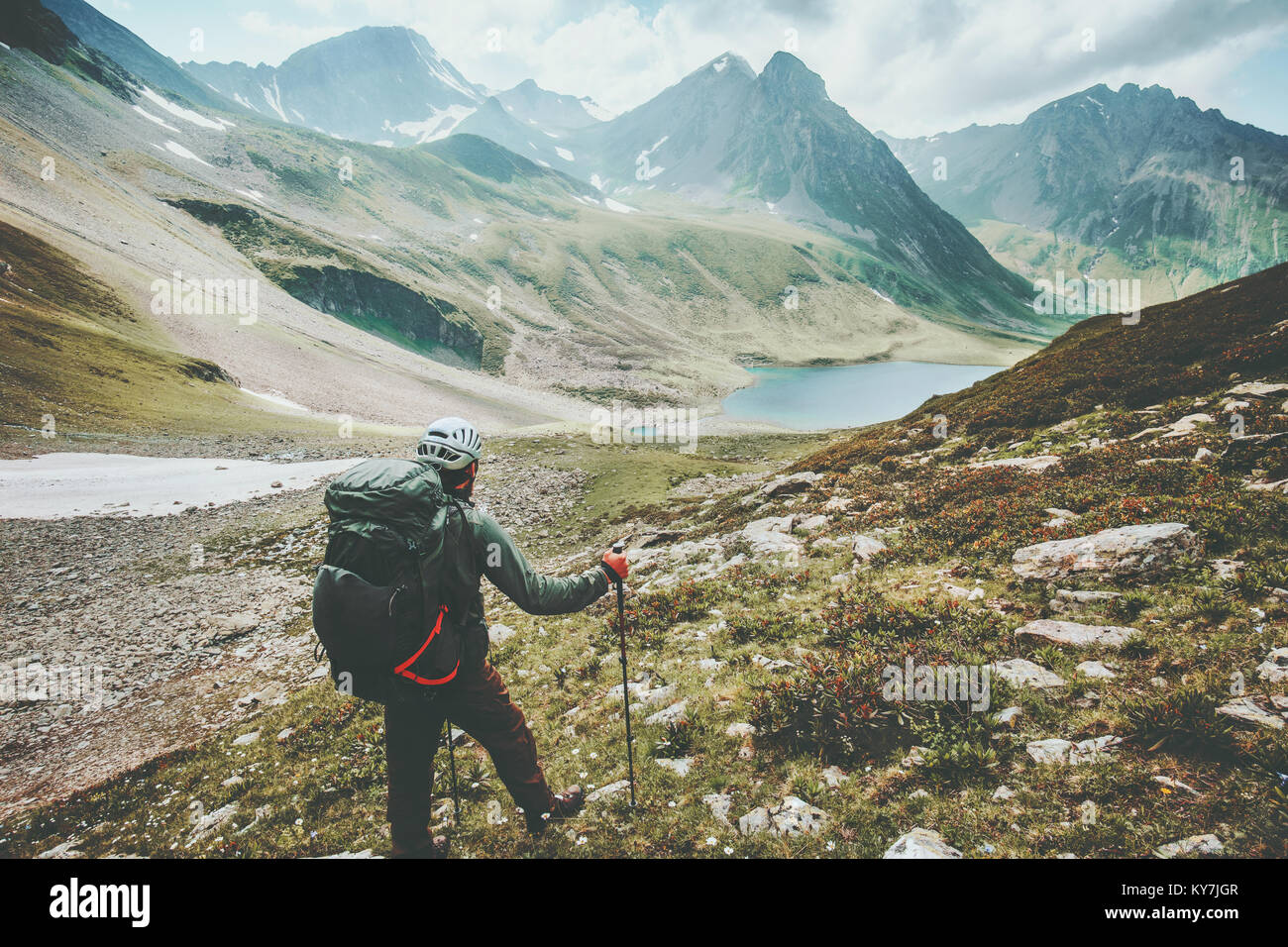 Adventurer man hiking in mountains with backpack Travel Lifestyle ...