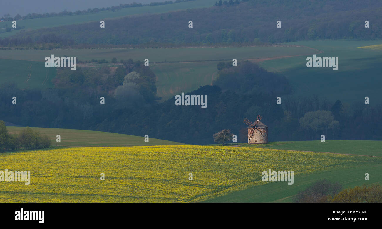 Rural abstract landscape with rolling hills and windmill in South ...