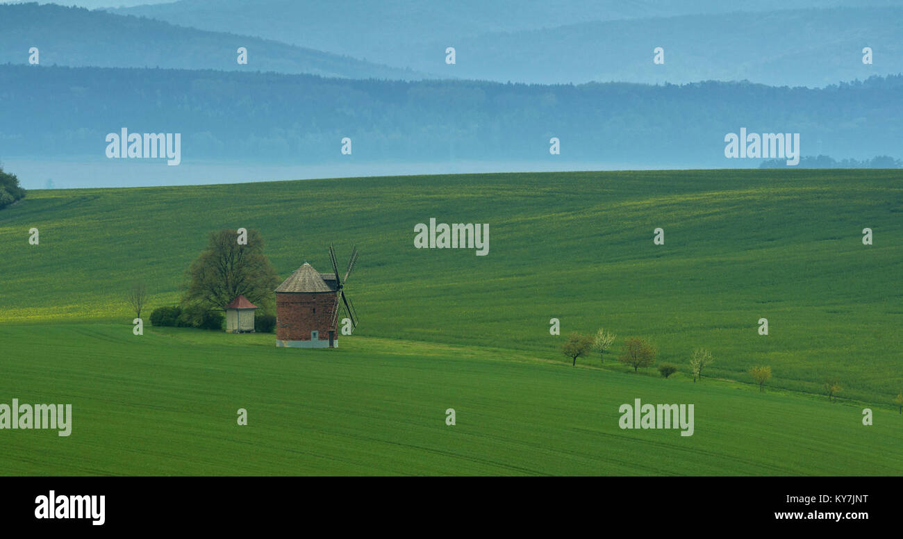Rural abstract landscape with rolling hills and windmill in South ...