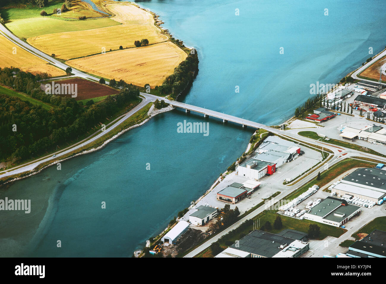 Aerial view of river and bridge between nature fields and city ecology ...