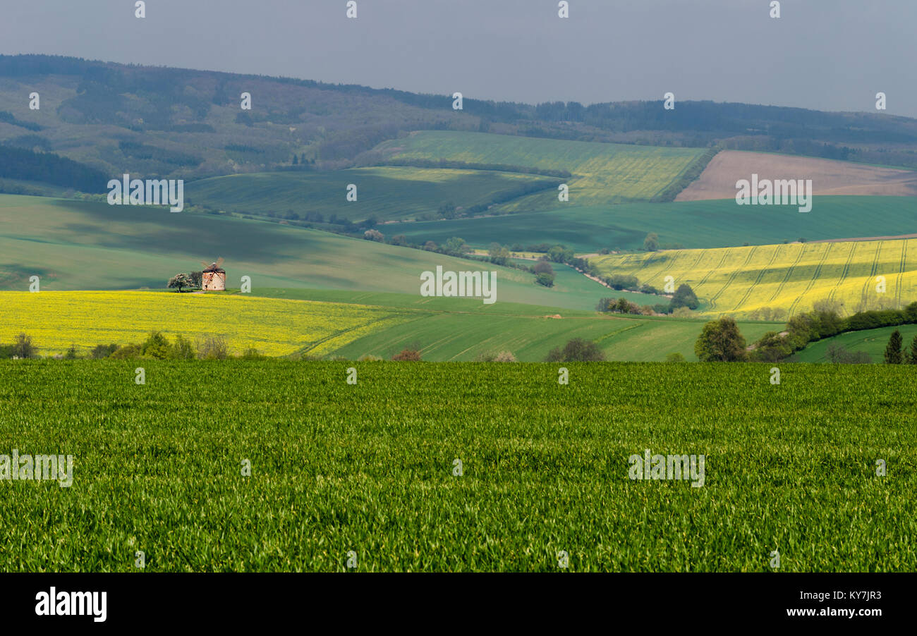 Rural abstract landscape with rolling hills and windmill in South ...