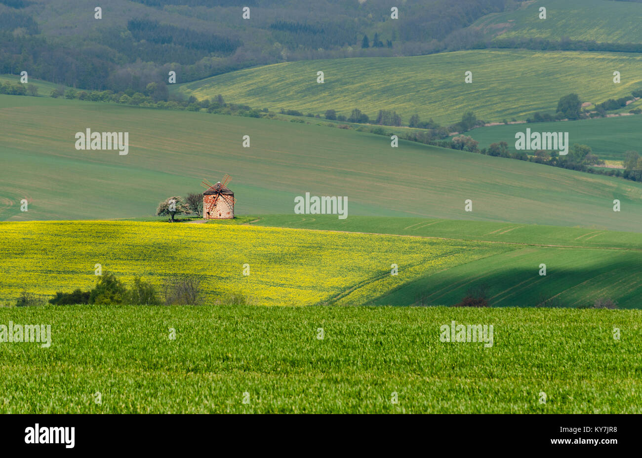 Rural abstract landscape with rolling hills and windmill in South ...