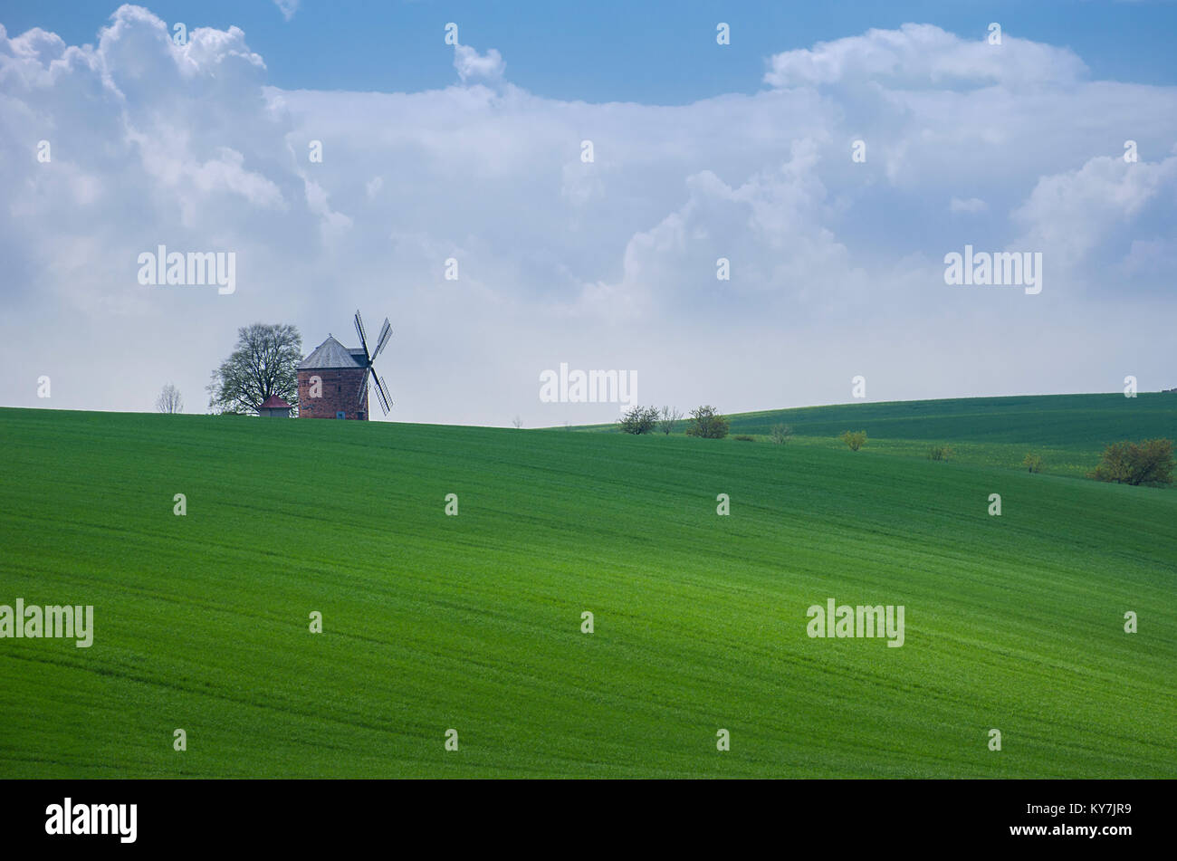 Rural abstract landscape with rolling hills and windmill in South ...