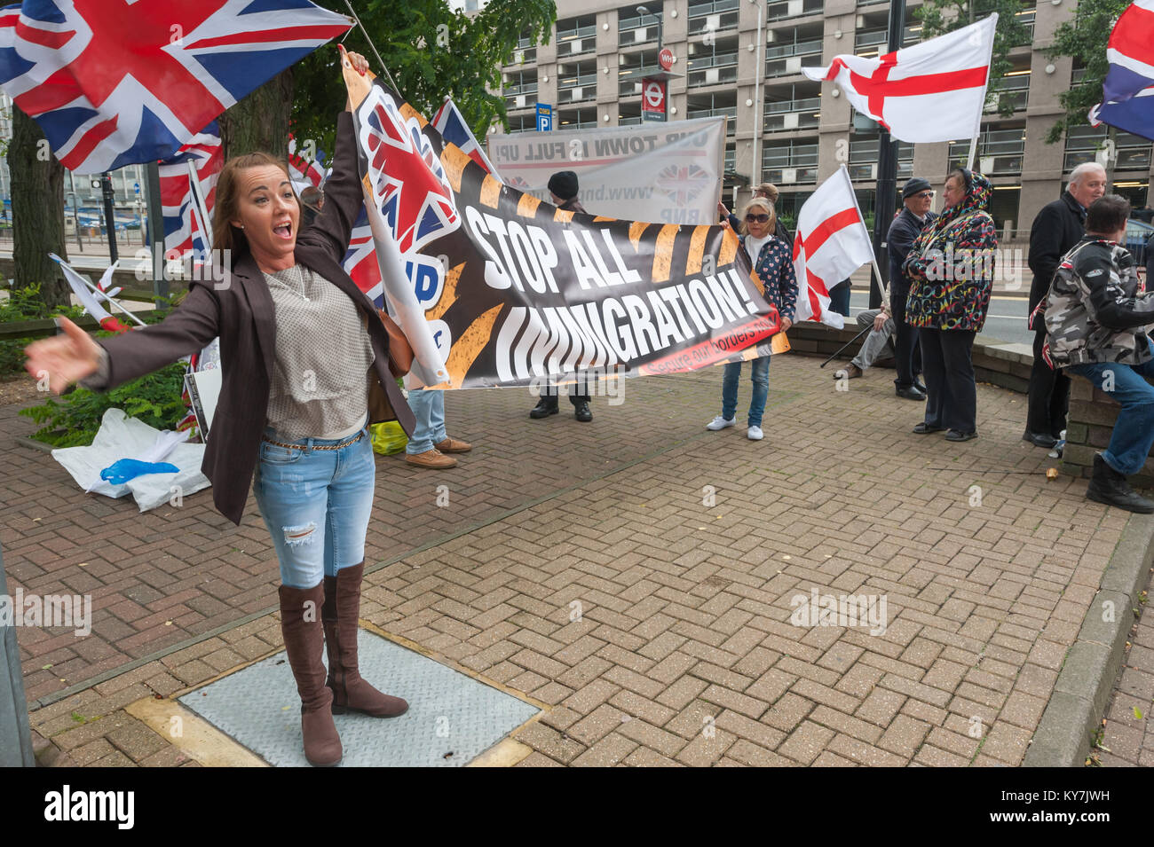 A woman holds the BNP Arop All Immigration' banner outside Lunar House ...