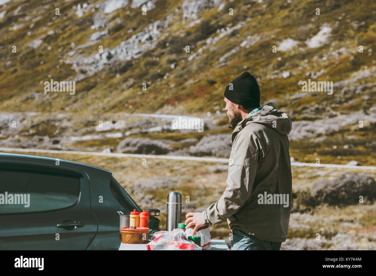 Outdoor kitchen Man cooking in mountains during road trip by car wild ...