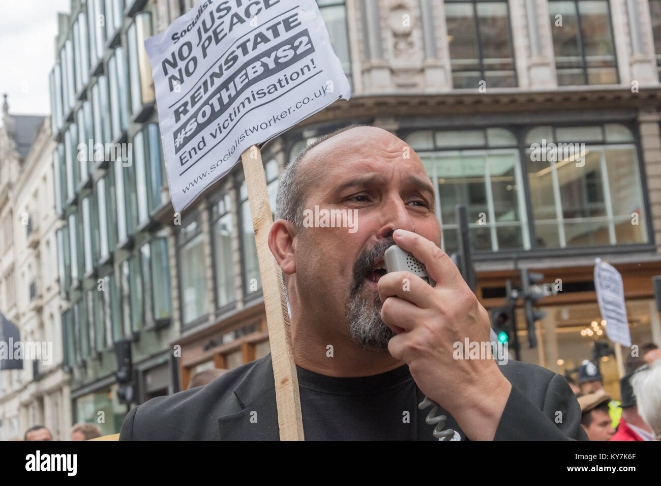 A man speaks into the megaphone at the United Voices of the World ...