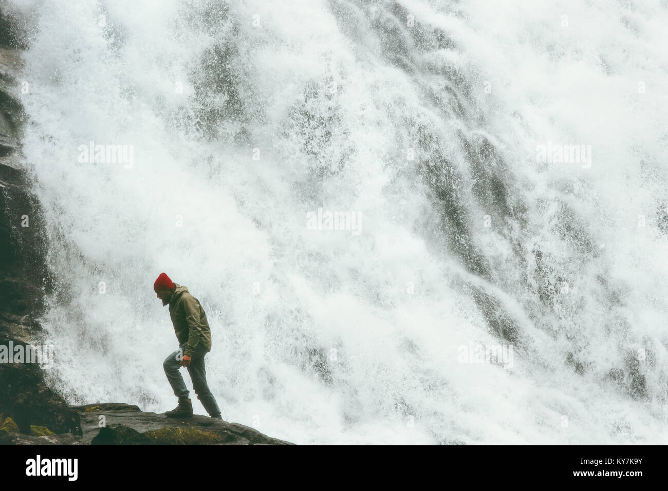 Man walking at big waterfall outdoor Travel Lifestyle survival concept ...