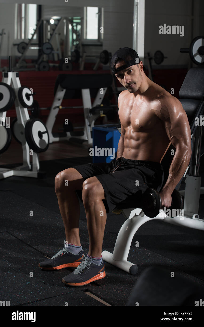 Man Working Out Biceps In A Gym - Dumbbell Concentration Curls Stock ...