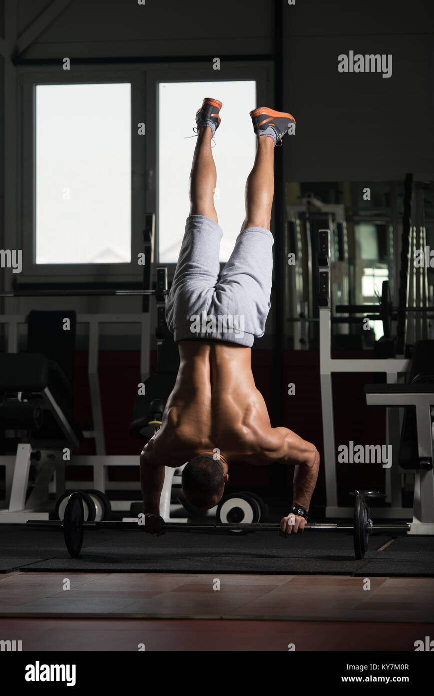 Bodybuilder Doing Push Ups On Barbell As Part Of Bodybuilding Training ...