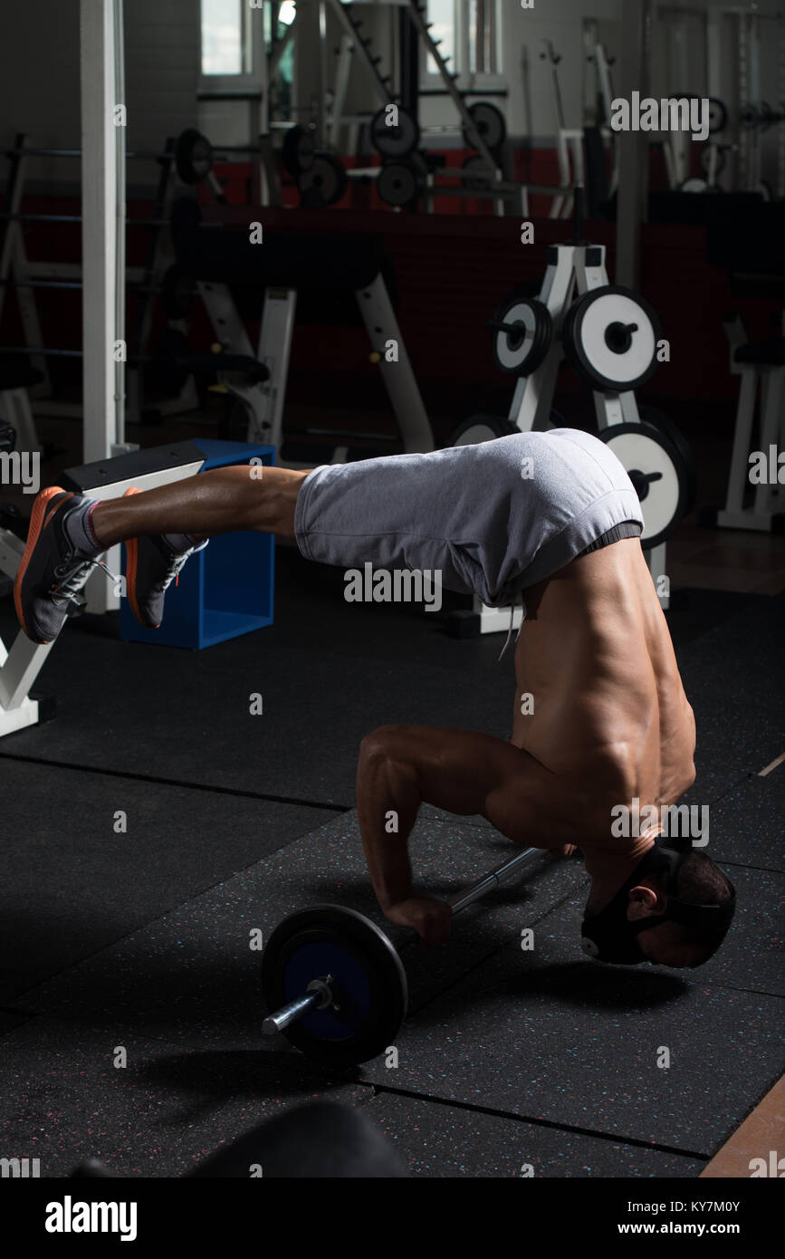 Bodybuilder Doing Push Ups On Barbell As Part Of Bodybuilding Training ...