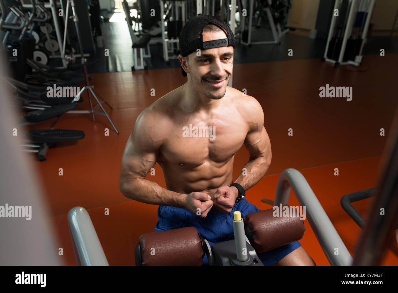 Healthy Young Man Standing Strong In The Gym And Flexing Muscles ...