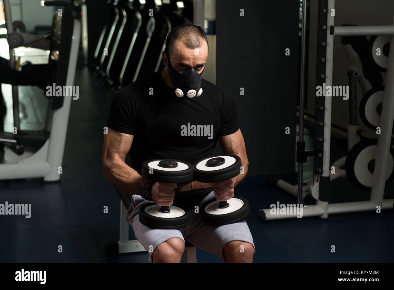 Athlete Working Out Biceps In Elevation Mask - Dumbbell Concentration ...