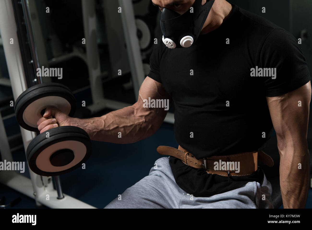 Athlete Working Out Biceps In Elevation Mask - Dumbbell Concentration ...