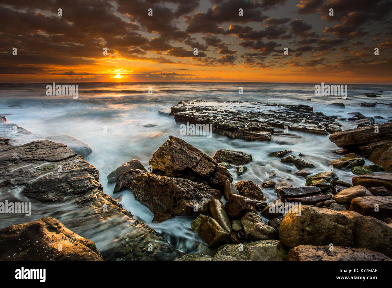 Sunrise over Rock Platform Stock Photo - Alamy