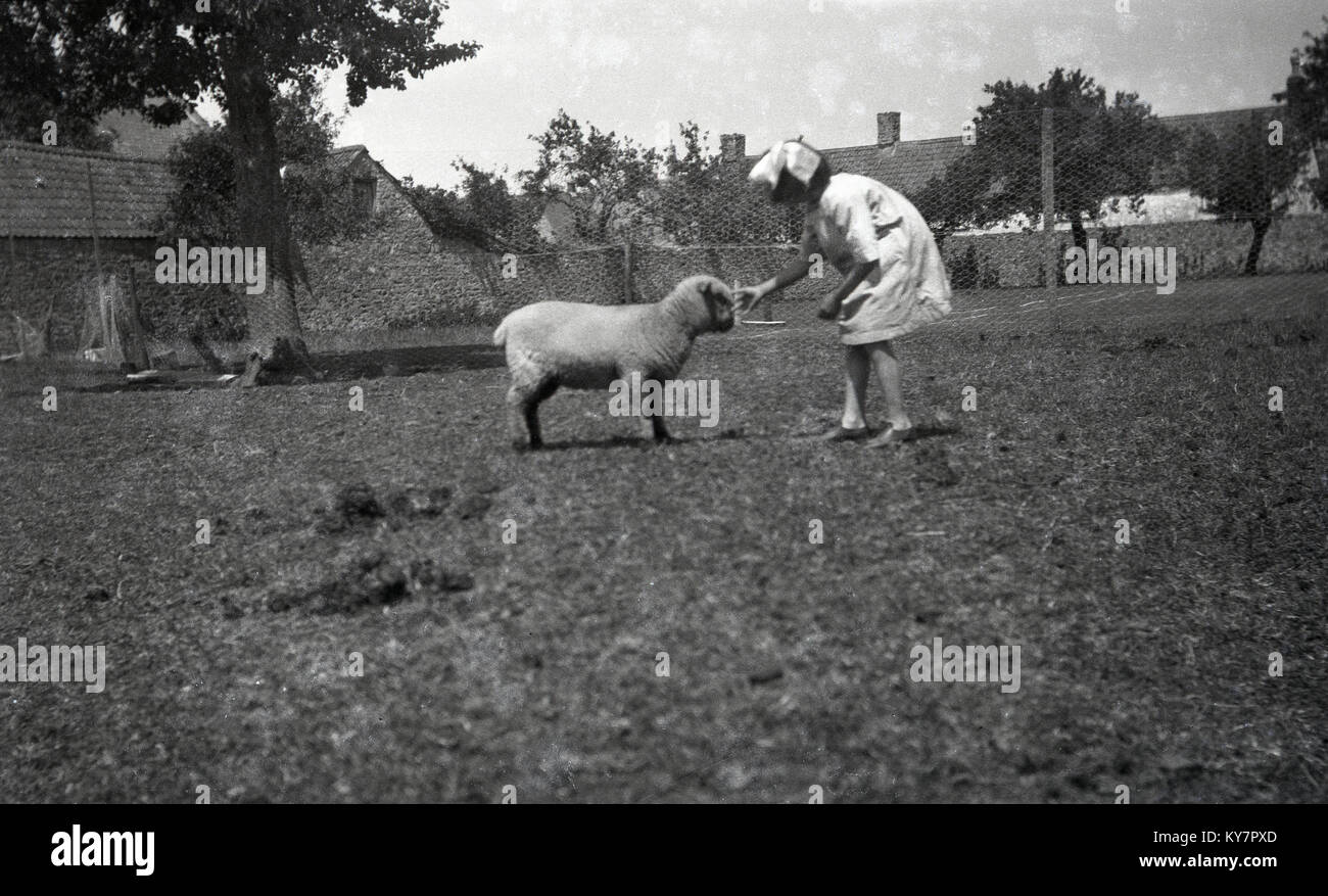 1920s, historical, picture shows a young girl weaing a dress in a large ...