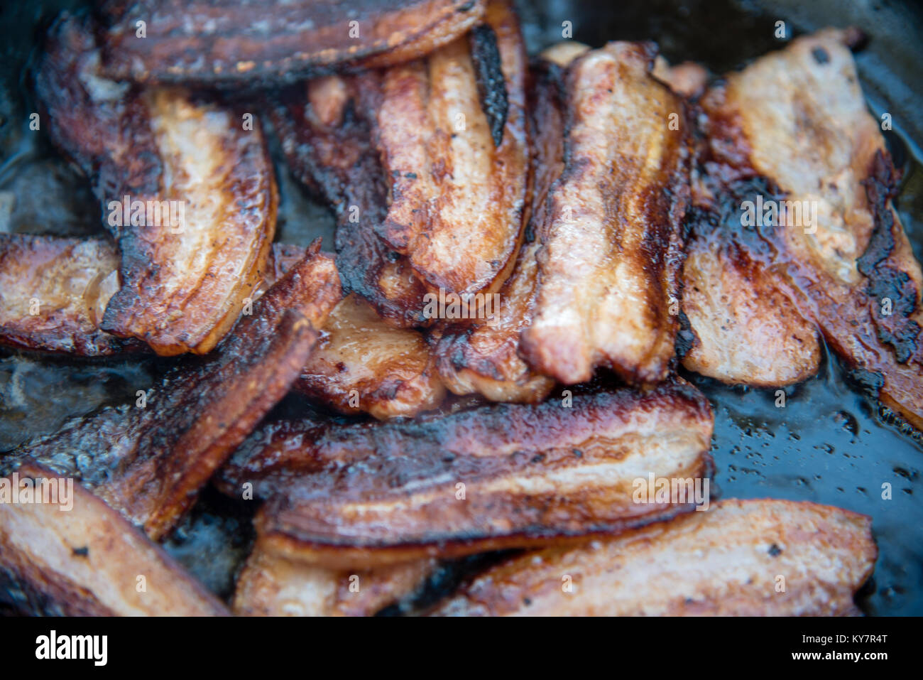 frying bacon in a pan over an open fire Stock Photo - Alamy