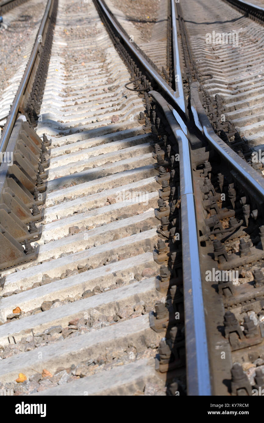 A set of train tracks crossing paths background Stock Photo - Alamy