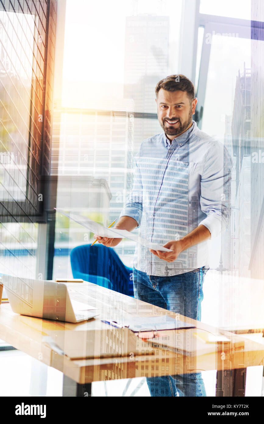 Positive delighted office worker looking at camera Stock Photo - Alamy