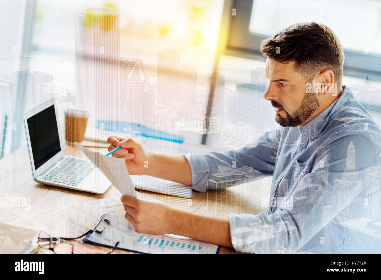 Serious male person checking documents Stock Photo - Alamy