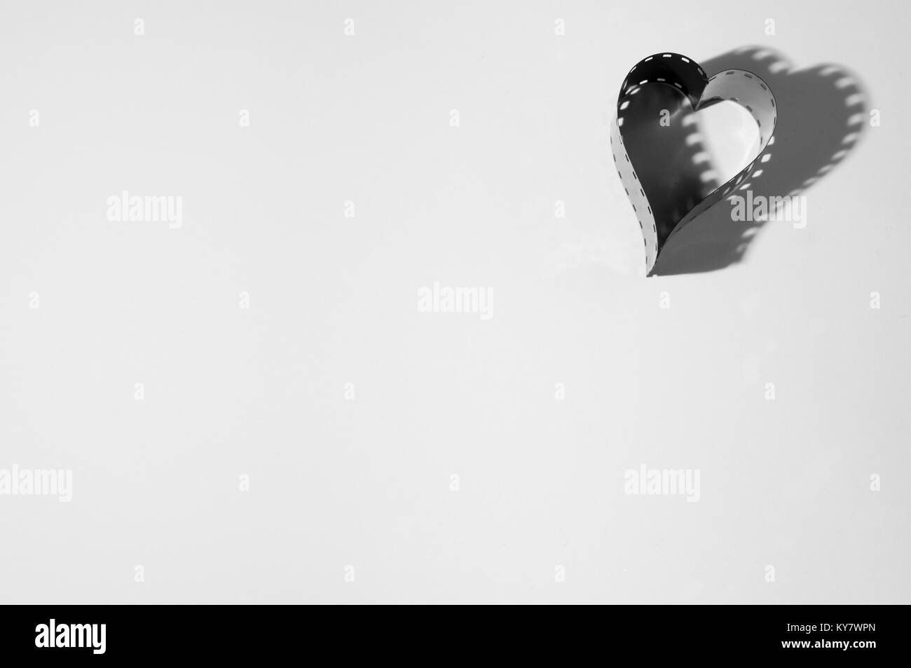 Heart shape made from a 35mm camera black and white film on white ...