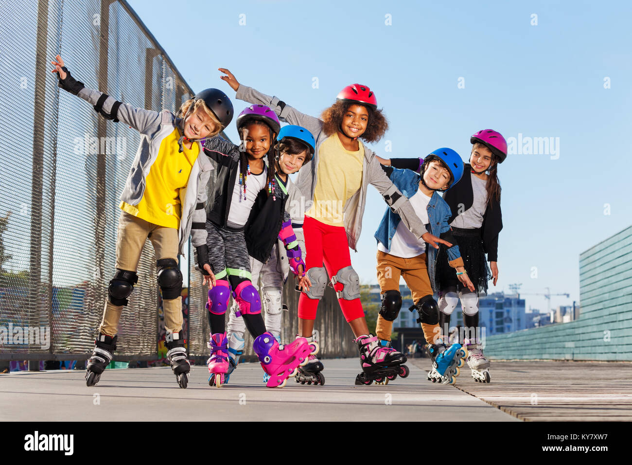 Portrait of multiethnic boys and girls, happy sporty inline skaters ...