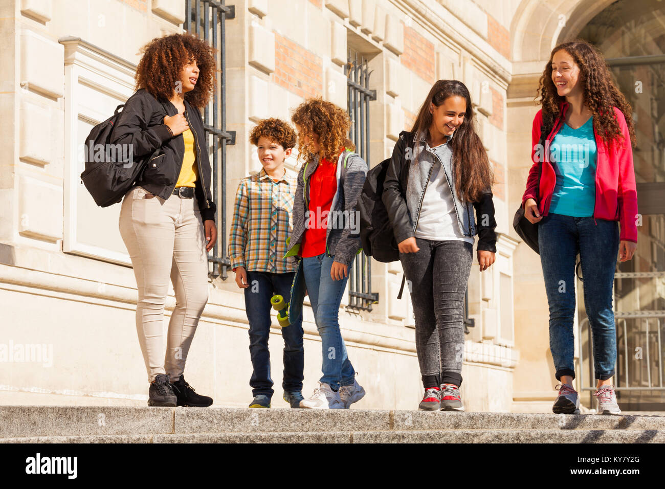Group of multiethnic students with backpacks at the college campus ...
