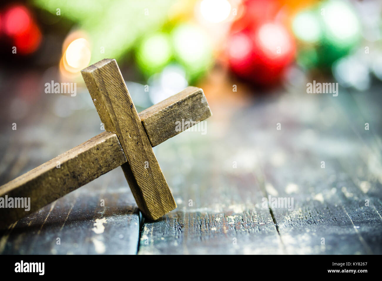 Traditional Christmas holiday ornaments and a holy Christian cross on a ...