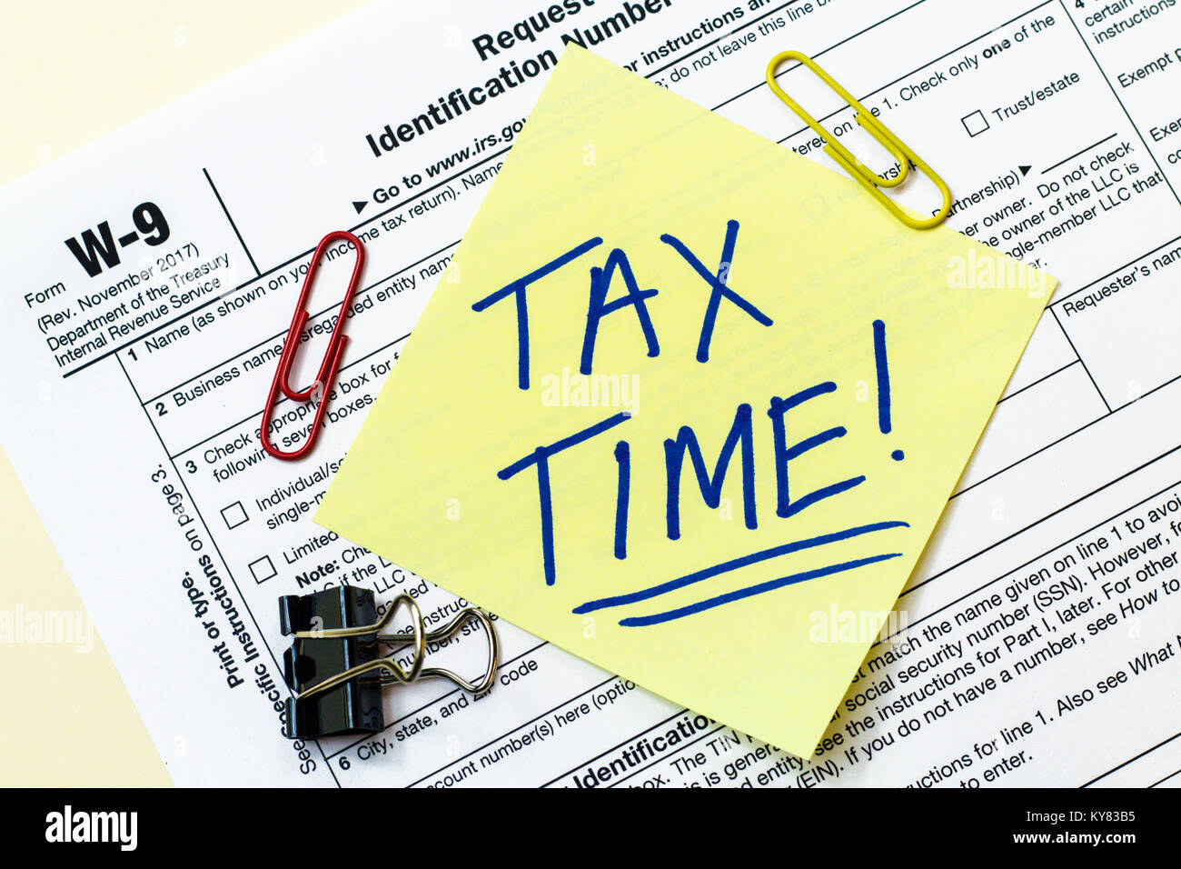 A W9 tax form with tax time written on a sticky note Stock Photo - Alamy