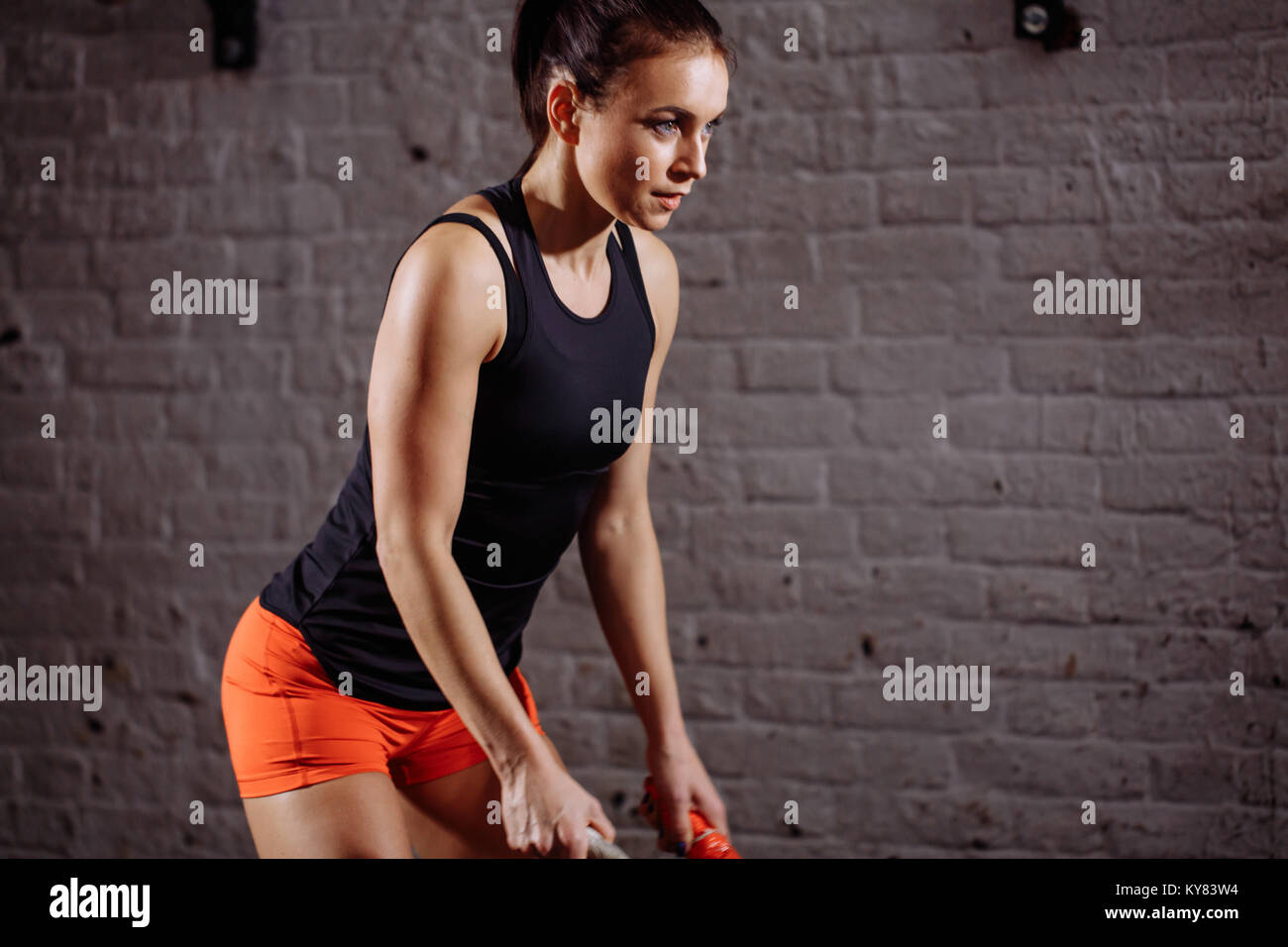 Powerful woman do workout with battle ropes in gym Stock Photo - Alamy