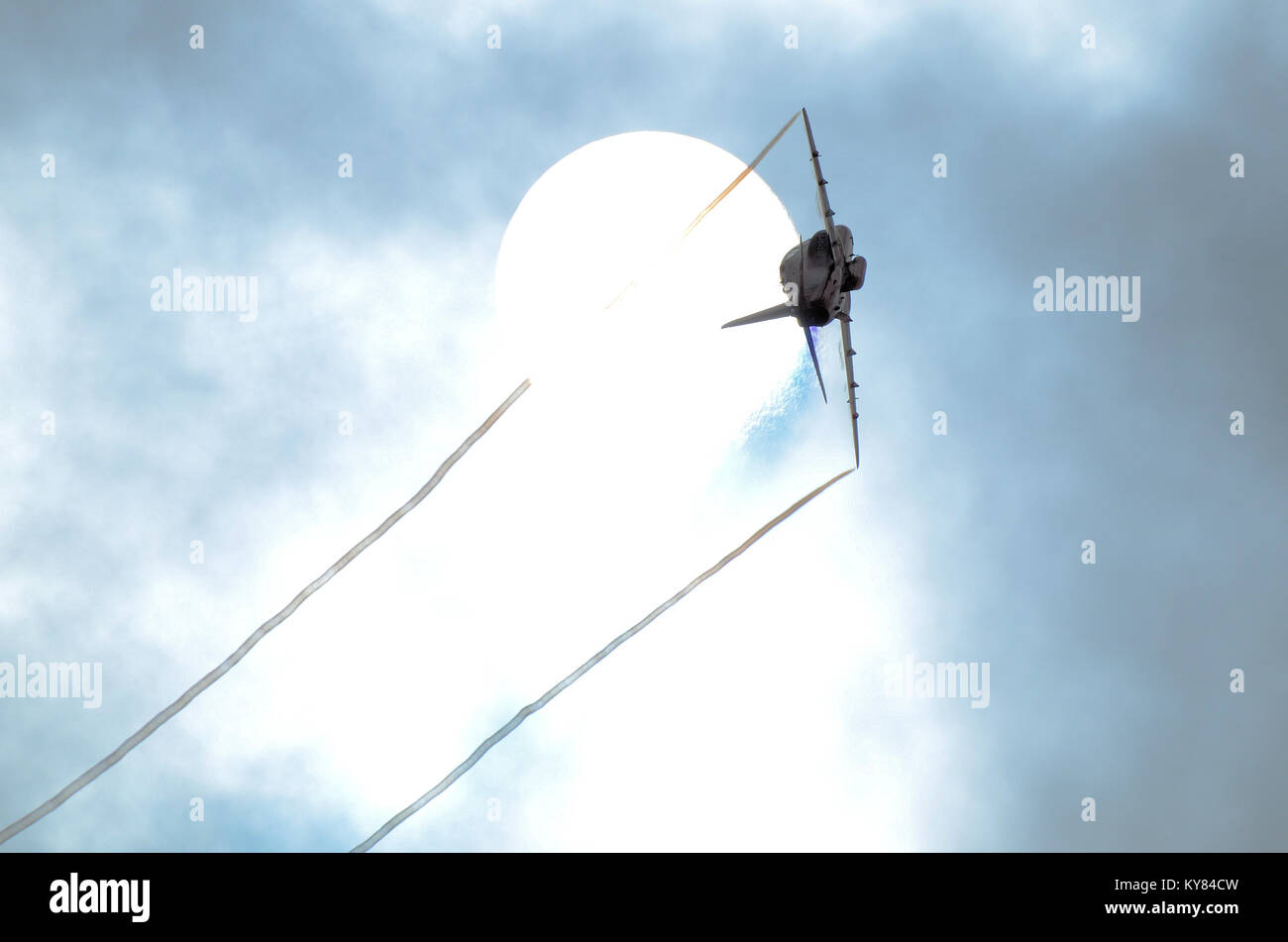 Royal Air Force Red Arrows jet plane heading into the sun trailing ...